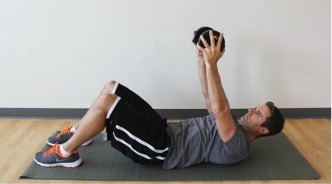 Sit-ups with a dumbbell - AthensTrainers®